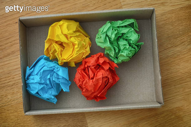Colorful crumpled paper balls in a cardboard box 이미지 (1746779727) - 게티이미지뱅크