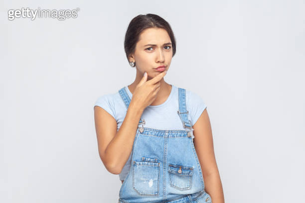 Woman pondering serious issues, looking with uncertain hesitant ...