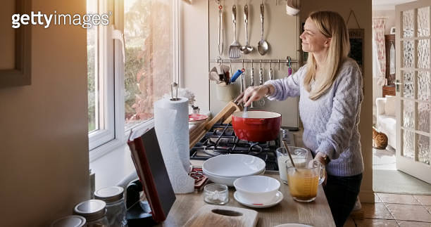 Woman, thinking and cooking in kitchen, food and nutrition or prepare ...