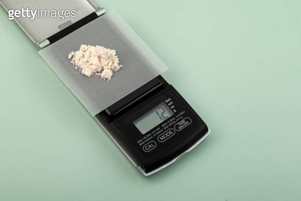Pile of Guar gum powder on accurate electronic digital scale. Food ...