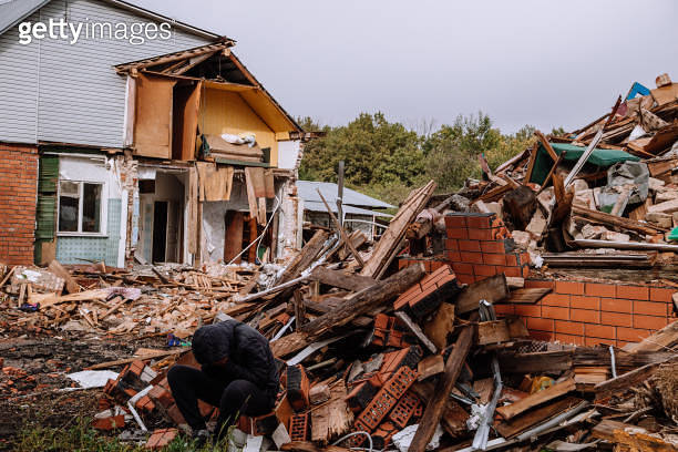Sad man on ruined house. Hopeless, homelessness, result of military ...