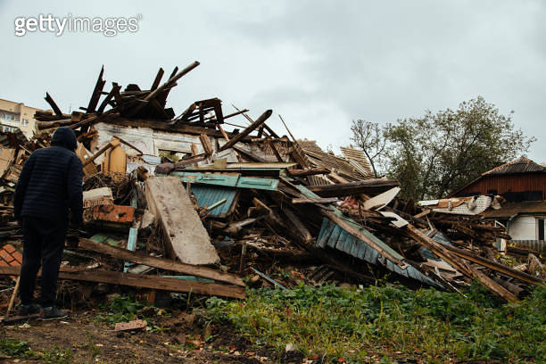 Sad man on ruined house. Hopeless, homelessness, result of military ...