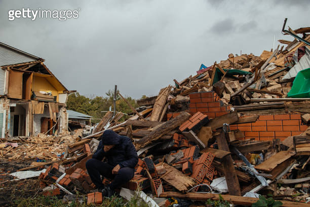 Sad man on ruined house. Hopeless, homelessness, result of military ...