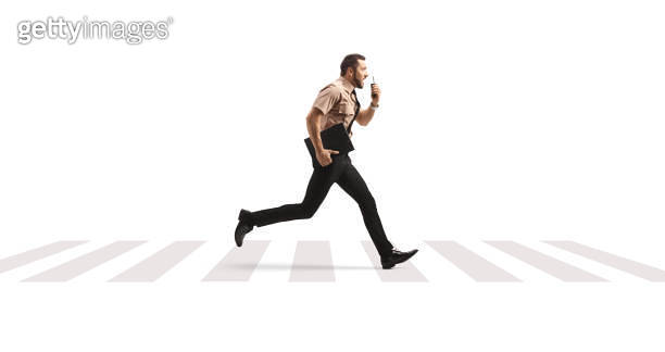 Full length profile shot of a security guard running at a pedestrian ...