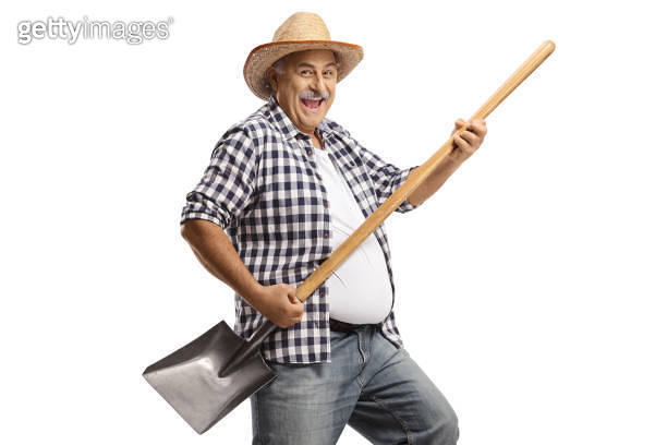 Mature farmer dancing with a shovel 이미지 (1866886212) - 게티이미지뱅크