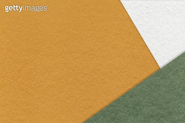 Texture of craft yellow and ocher color paper background with white and ...