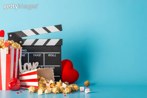 Romantic evening at movies on Valentine's Day: side view clapper, boxes ...