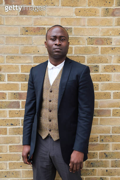 Distinguished Man Poses Gracefully, Framed by a Brick Wall 이미지 ...
