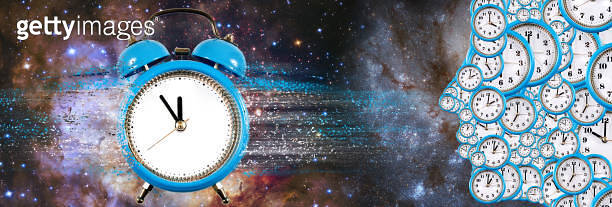 An image of a clock, from which particles and a human head are ...