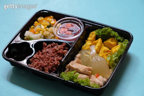 healthy food bento with brown rice, yellow shredded chicken, vegetable ...