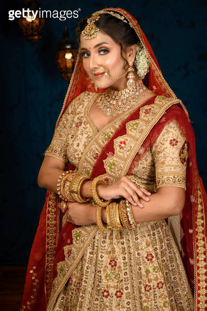 Stunning Indian bride dressed in traditional bridal lehenga with heavy ...