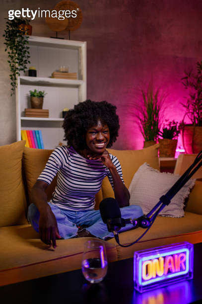 Portrait of an african american radio presenter recording an internet ...
