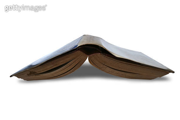 Rustic opened old book facing down on floor, cut out isolated ...