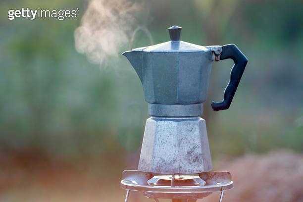 Moka pot and smoke, Steam from the coffee pot on fire, In the forest at ...