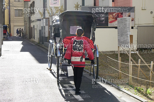 Rickshaws wearing traditional costumes in a back alley in Asakusa ...