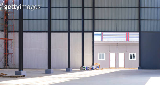 View from inside of large warehouse building structure in construction ...