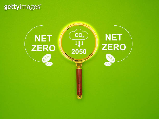 Reduce CO2 emission icon inside the magnifier glass for focusing decrease CO2 or carbon dioxide ...