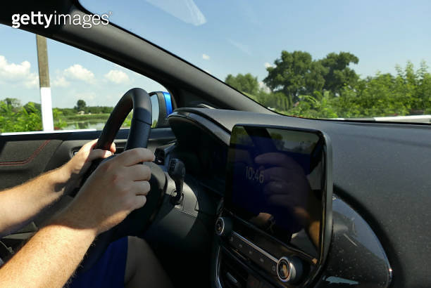 Human Hands On A Steering Wheel Inside Fast Moving Car (1765135632 ...