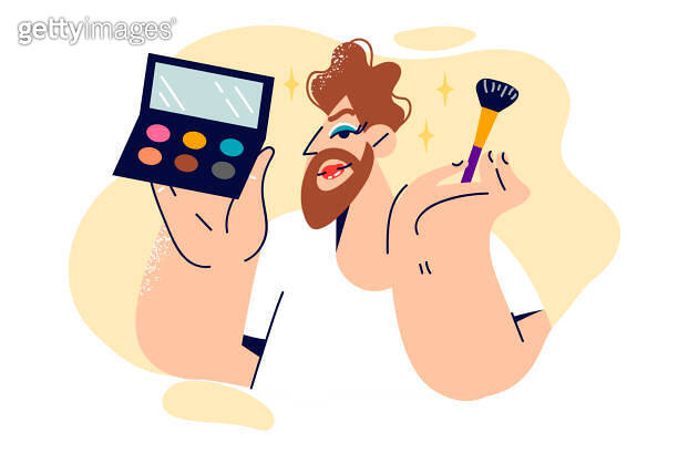 Non-binary man does own makeup and holds brush with multi-colored ...