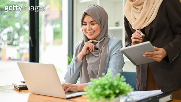 Professional Muslim business team working together, discussing on an ...