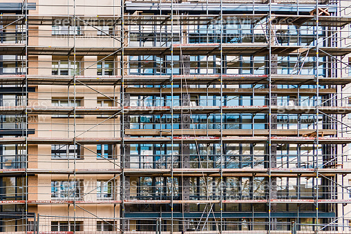 scaffold building renovation construction site.Front exterior view of ...