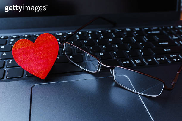 Remote senior date concept.distant video chat,red heart laptop keyboard ...