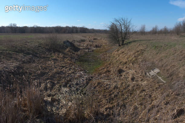 The bottom of a dry irrigation canal. Abandoned and shallow land ...