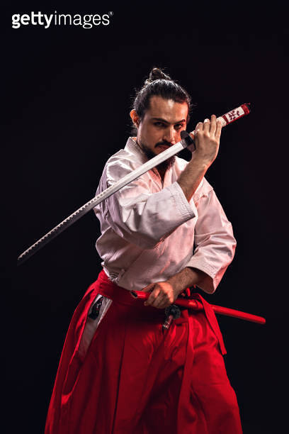 portrait of a brazilian with samurai costume, holding his sword with ...