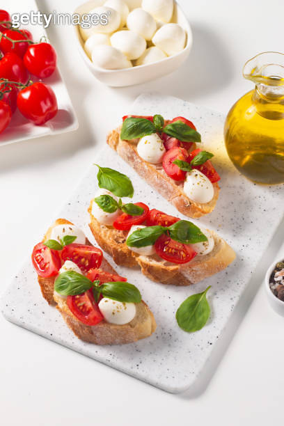 Tomato, basil and mozzarella cheese fresh made caprese bruschetta. Italian tapas, antipasti with ...