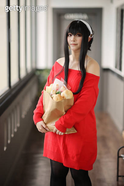 Portrait of a beautiful young woman Cosplay with red sweater with bread ...