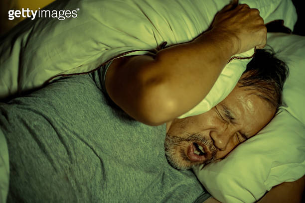 depressed old man and stressed lying in bed from insomnia,focus on face ...
