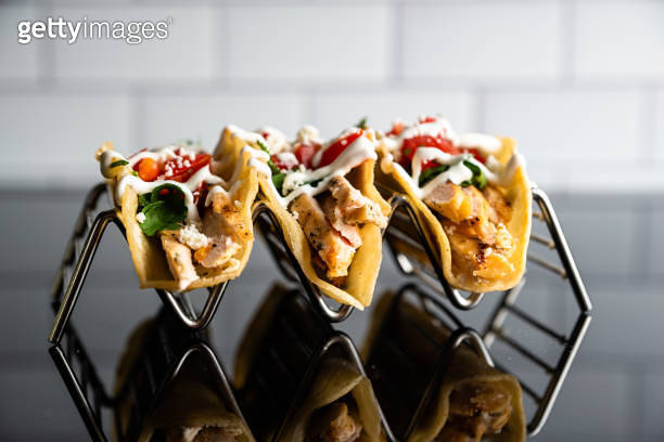 This mouth-watering photo showcases three delicious street tacos on a ...