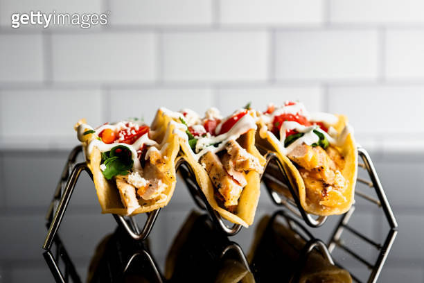 This mouth-watering photo features three street tacos arranged on a ...