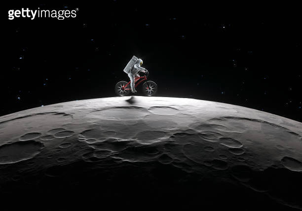 Astronaut riding a bike on the moon. Futuristic and creative concept ...