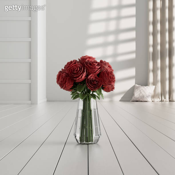 A bouquet of roses in a glass vase in an empty room. Rose vase at the ...