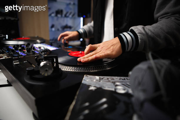 Cool hip hop DJ scratching a record. Disc jokey mixing musical tracks ...