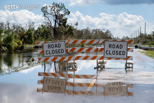 Flooded street in Florida after hurricane rainfall with road closed ...