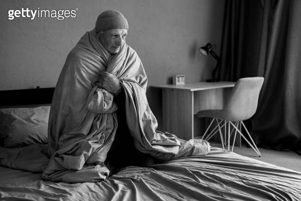 It's cold at home in wintertime. Old man freezing in his house in ...