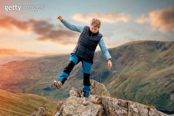 Woman reaching the destination and on the top of mountain against ...