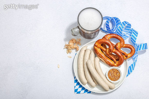 Traditional Oktoberfest set. Pretzels, beer, weisswurst with mustard ...