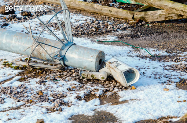 Damaged surveillance camera on the ground as a concept of failing ...