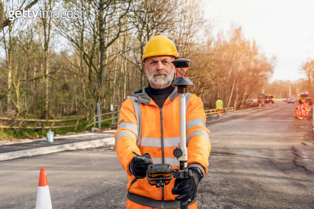 Site engineer operating his touch screen controller instrument during ...