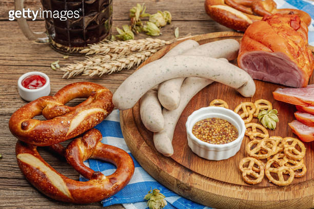 Traditional Oktoberfest set. Pretzels, beer, weisswurst, eisbein with ...