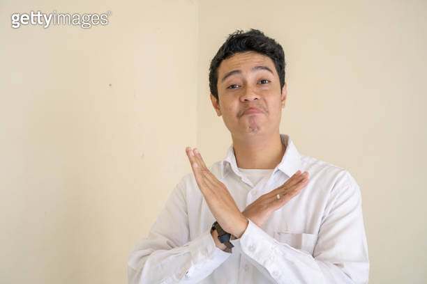 Young Indonesian curly man wear white clothes with rejected pose. 이미지 ...