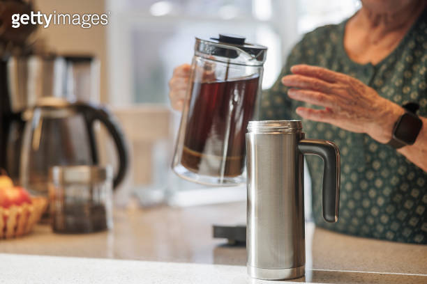 Energy efficiency and prolonged heat retention. Senior woman hands ...