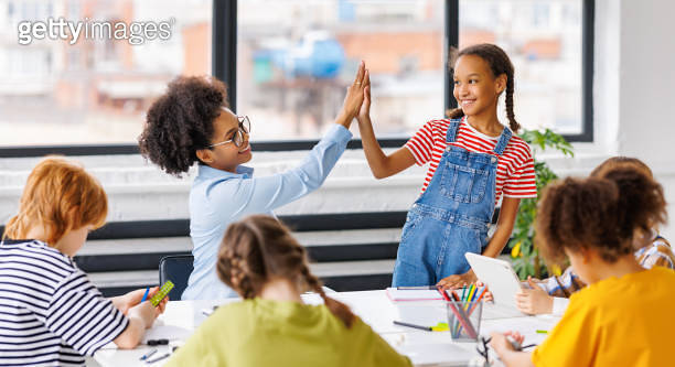 Teacher and joyful students celebrate successful completion of ...
