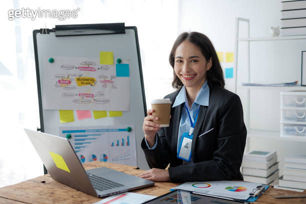 Asian Businesswoman Using laptop computer and working at office with ...