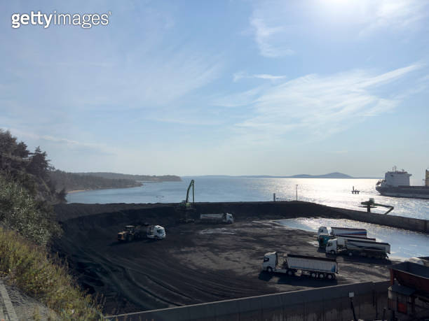 The port of a cement factory. Raw materials arriving by dry cargo ships ...