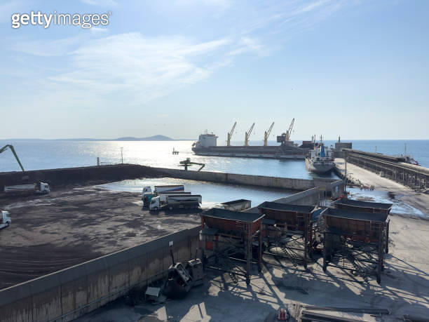 The port of a cement factory. Raw materials arriving by dry cargo ships ...