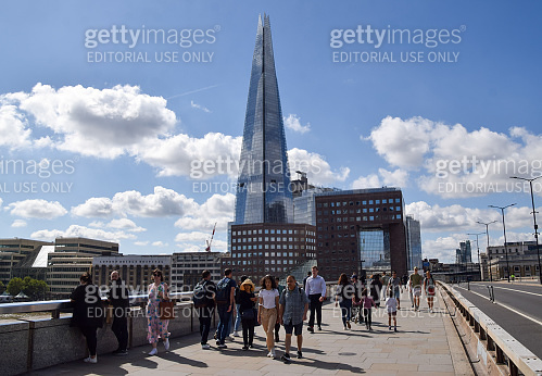 People walk along London Bridge past the Shard, London, UK (1619259693 ...